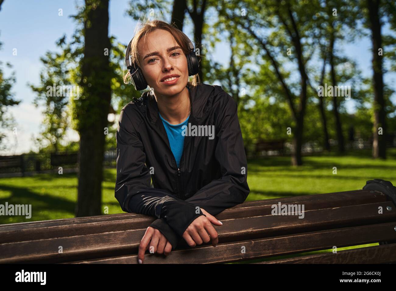 Jolly woman relaxing in park with headphones Stock Photo - Alamy