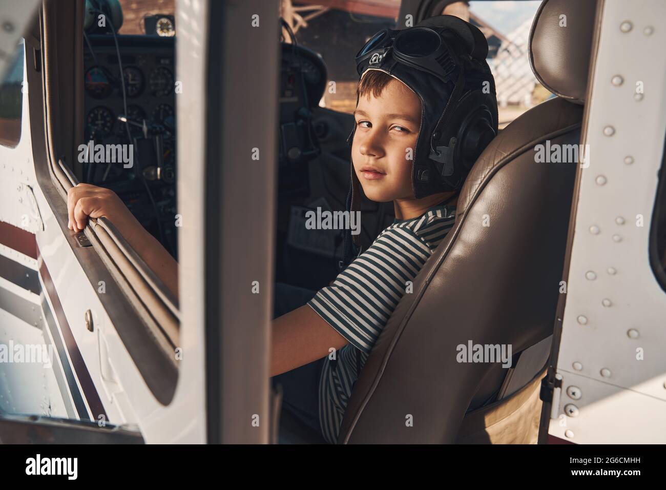 Adorable male child sitting inside airplane cockpit Stock Photo - Alamy
