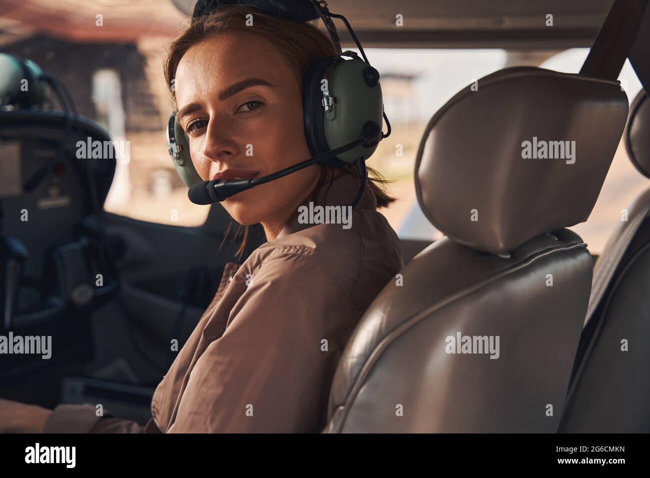 Beautiful young woman sitting inside plane cockpit Stock Photo - Alamy