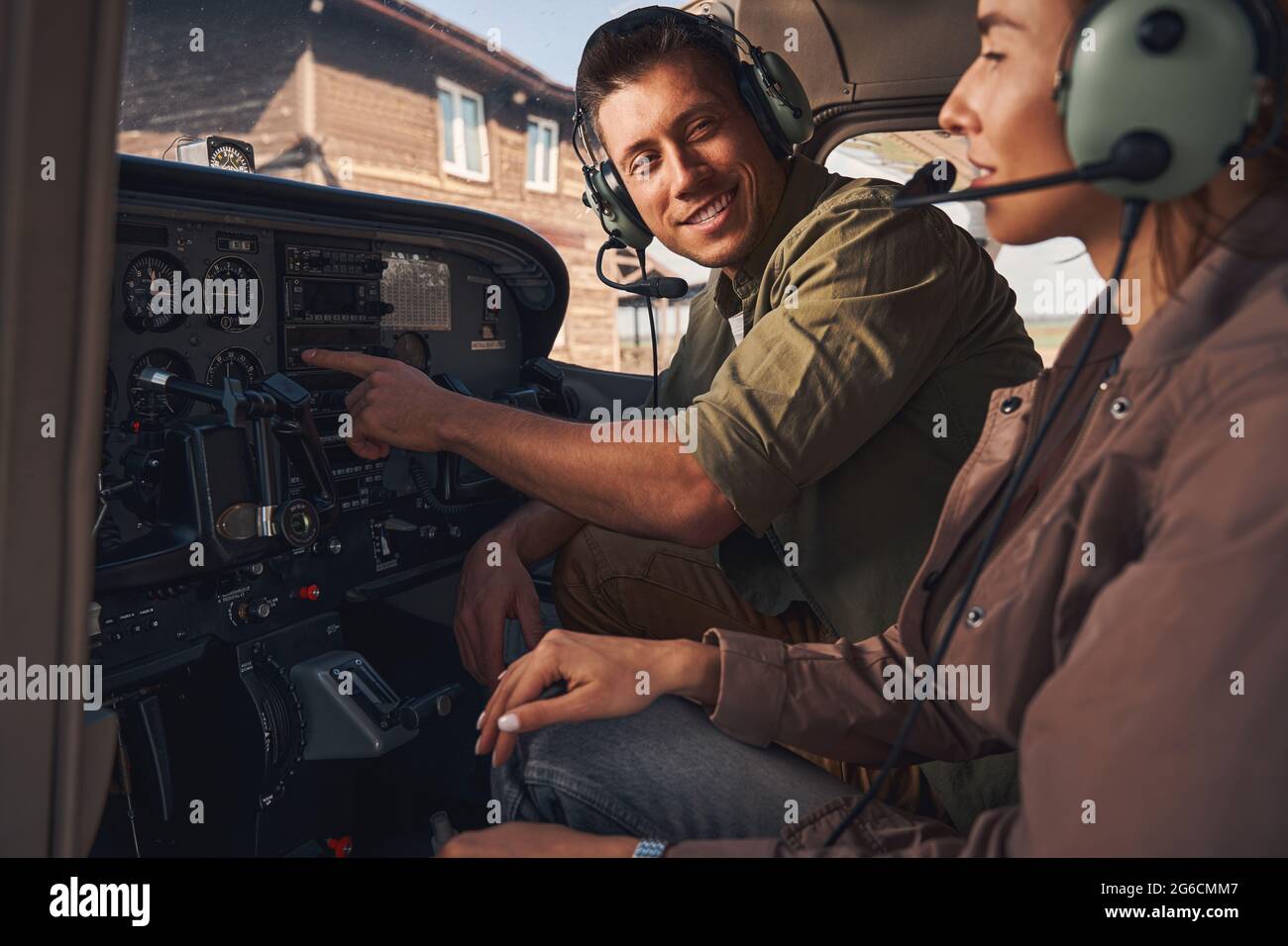 Charming young woman learning to fly aircraft Stock Photo - Alamy