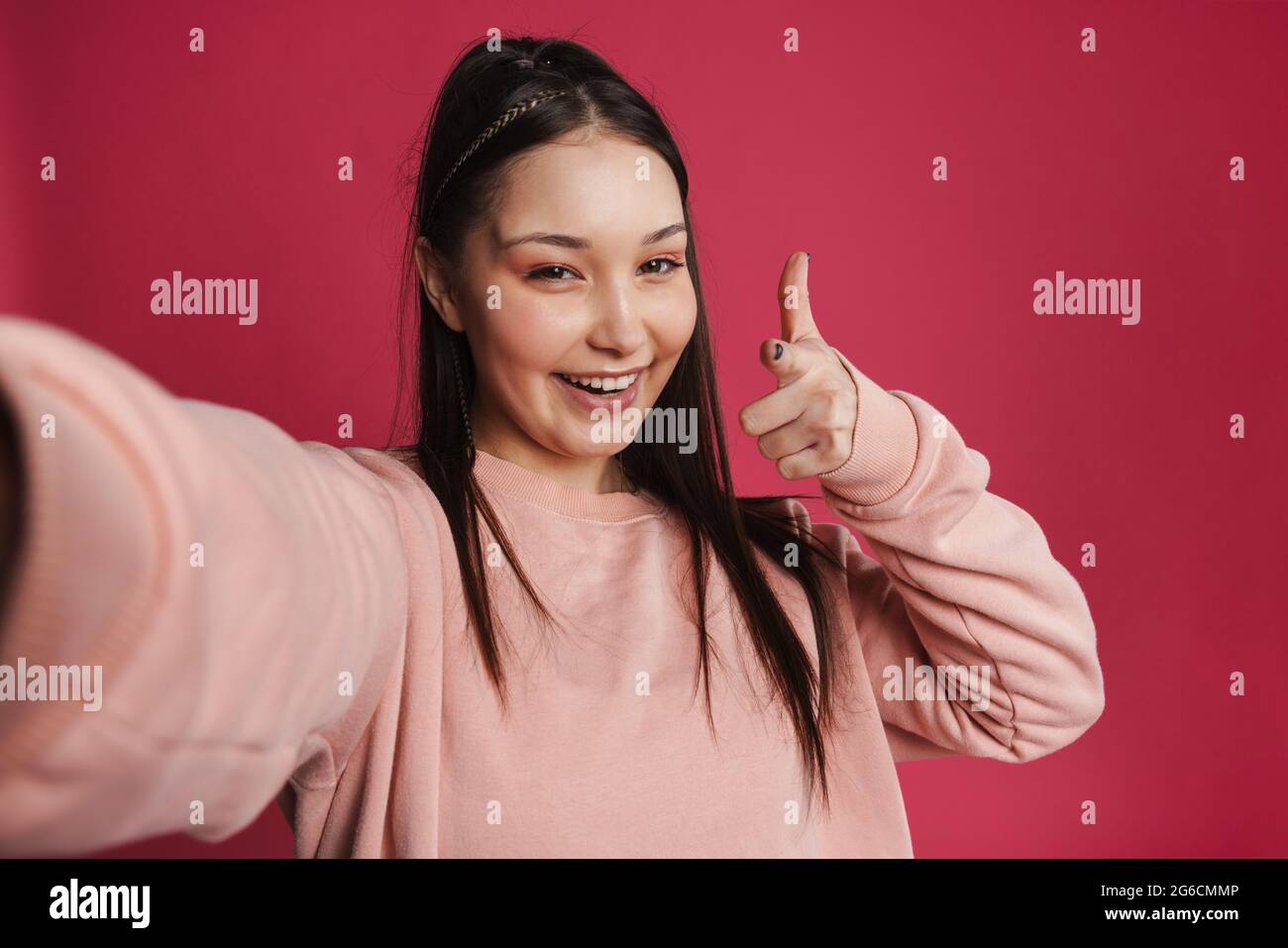 Asian happy woman pointing finger at camera while taking selfie photo ...