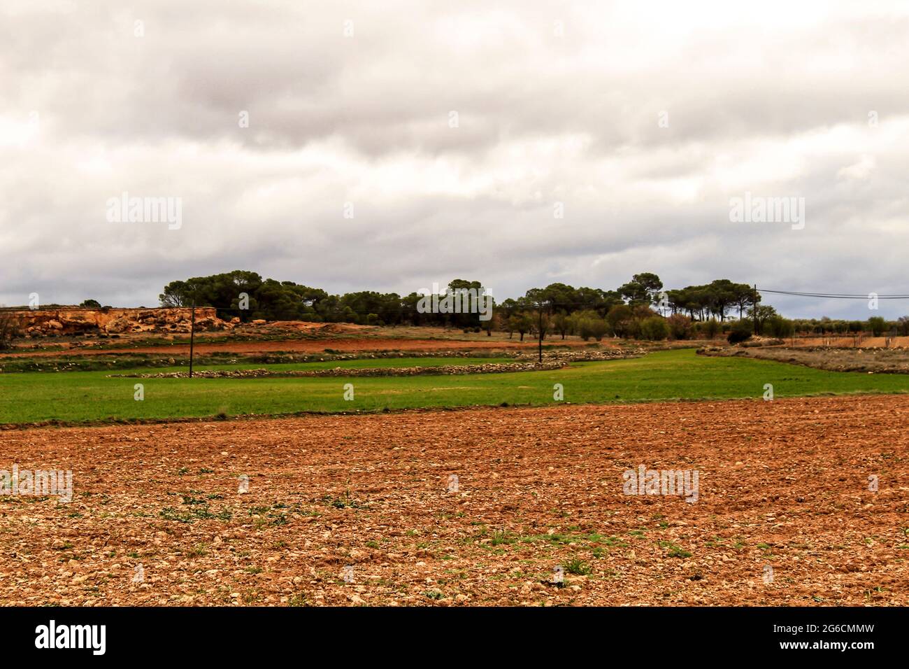 Landscape with cloudy sky and farm field in Castilla La Mancha, Spain ...