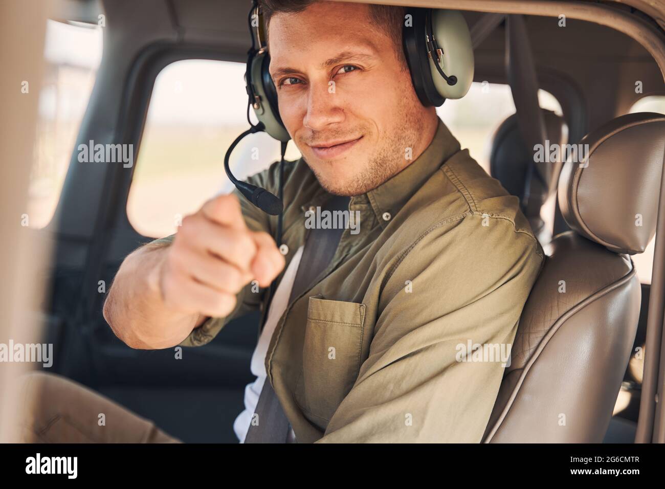 Joyful young man sitting inside plane cockpit Stock Photo - Alamy