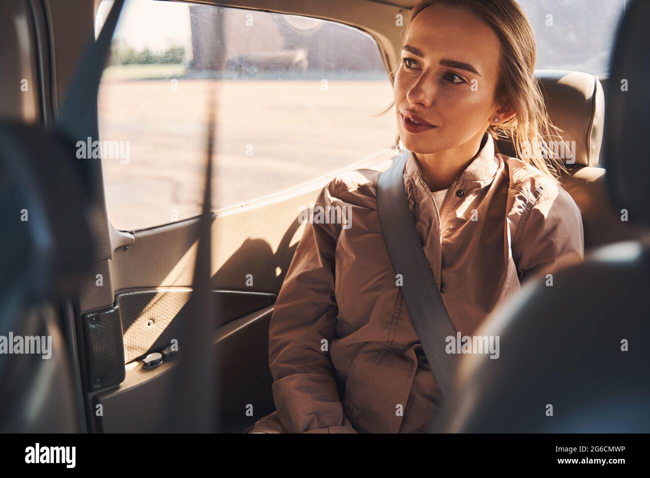 Beautiful young woman sitting on passenger seat in vehicle Stock Photo ...