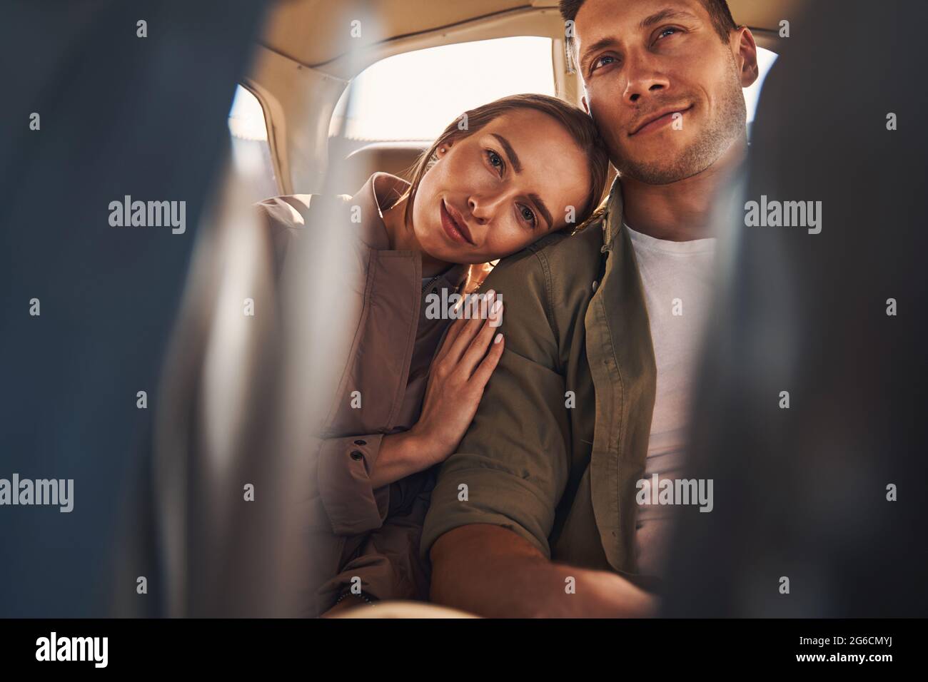 Beautiful young couple in love sitting in car Stock Photo - Alamy