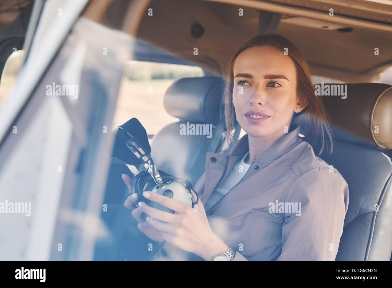 Beautiful young woman sitting in aircraft pilot cabin Stock Photo - Alamy