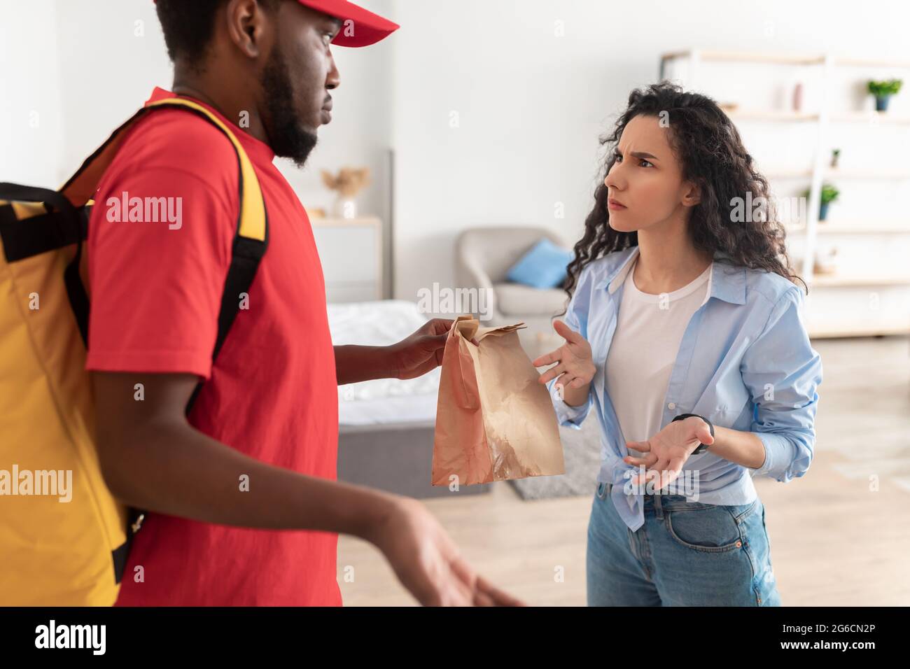 Portrait of confused angry woman complaining about bad food delivery ...
