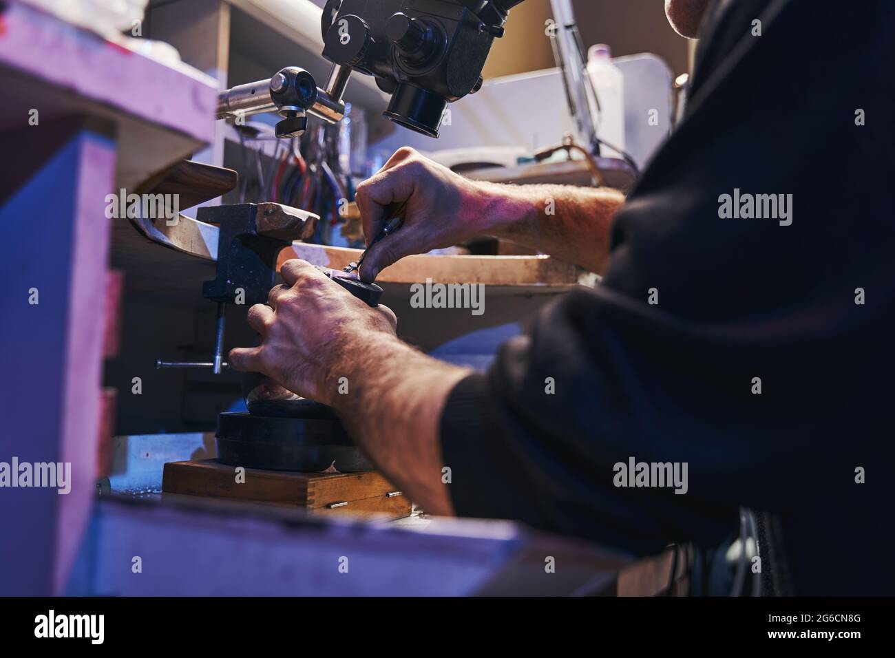 Person pushing claws over stone during setting with tool Stock Photo ...