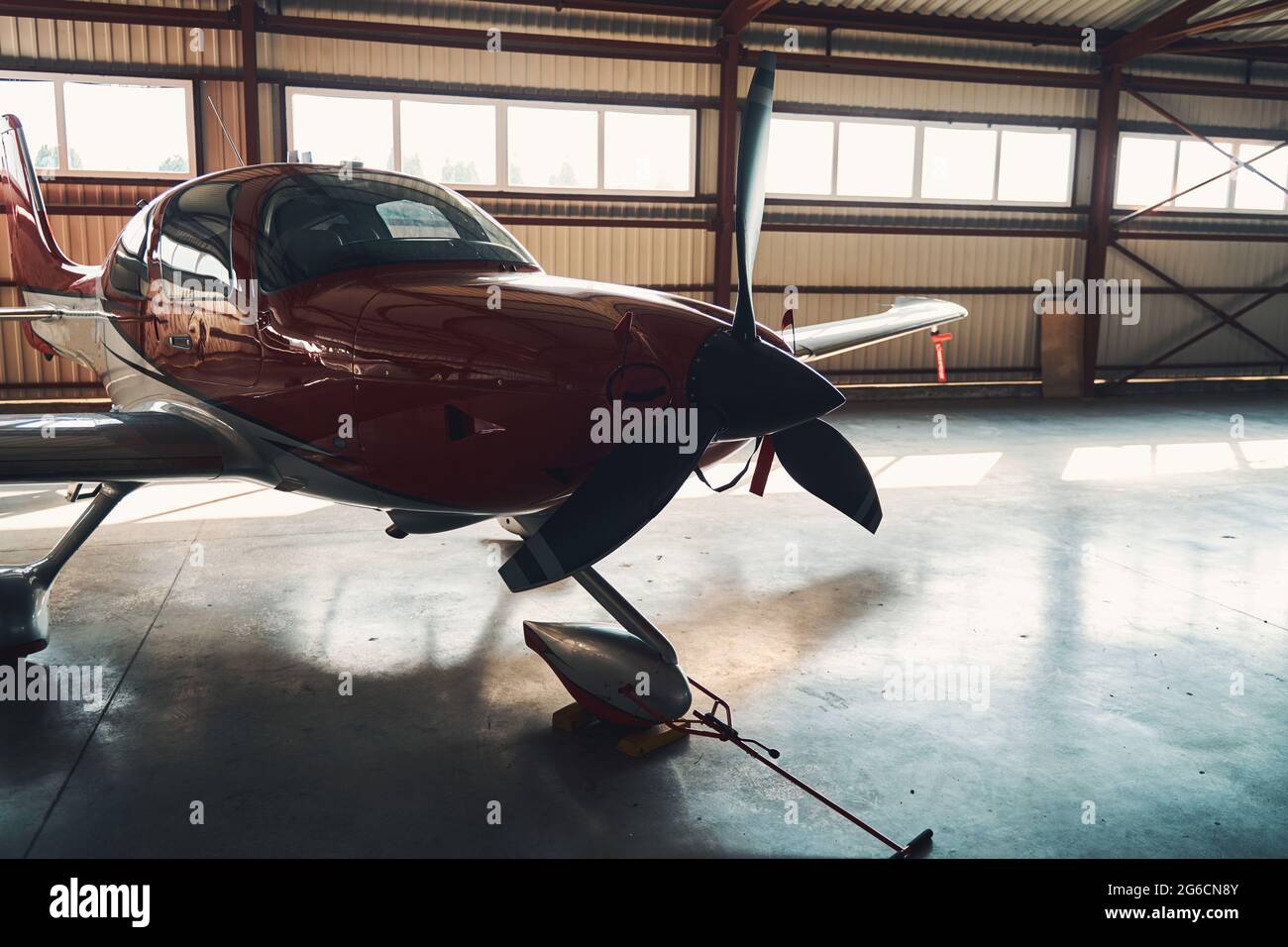 Airport parking building with modern light aircraft Stock Photo - Alamy