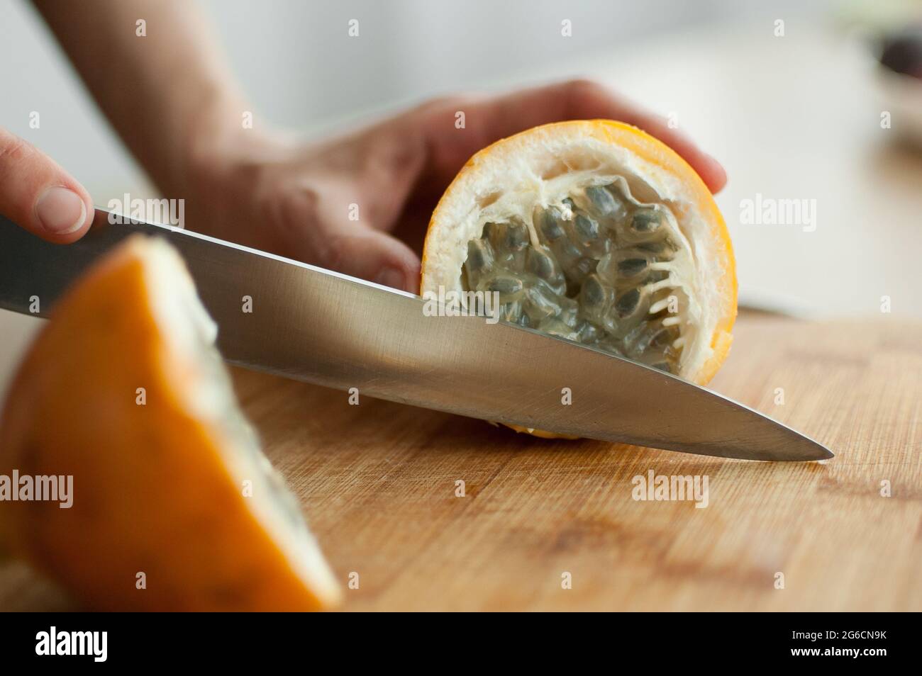 Fresh organic ripe granadilla or yellow passion fruit cut in half on a ...
