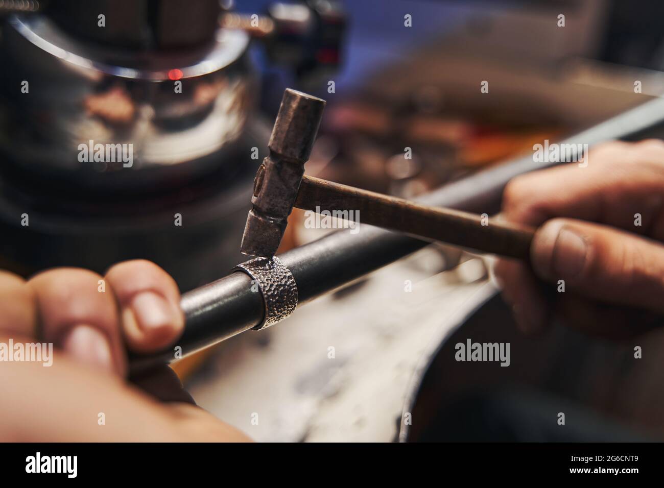 Craftsmen is peening silver ring with hammer Stock Photo - Alamy
