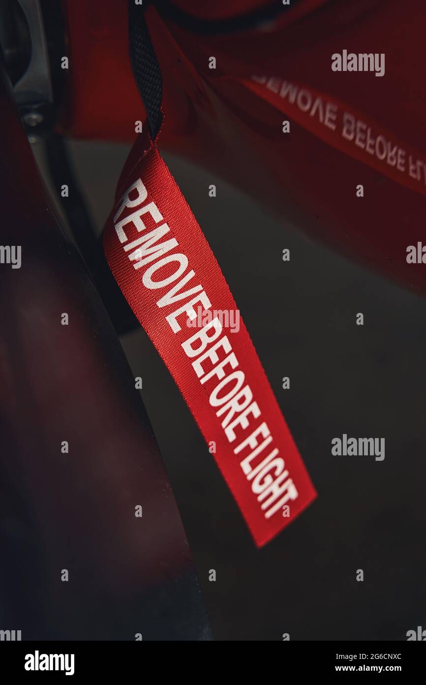 Remove before flight label on red aircraft Stock Photo - Alamy