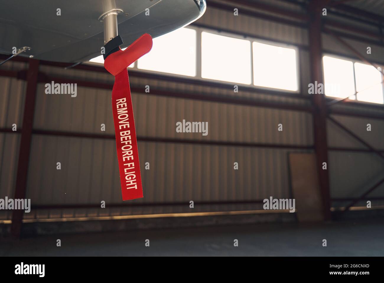 Remove before flight label on white aircraft Stock Photo - Alamy