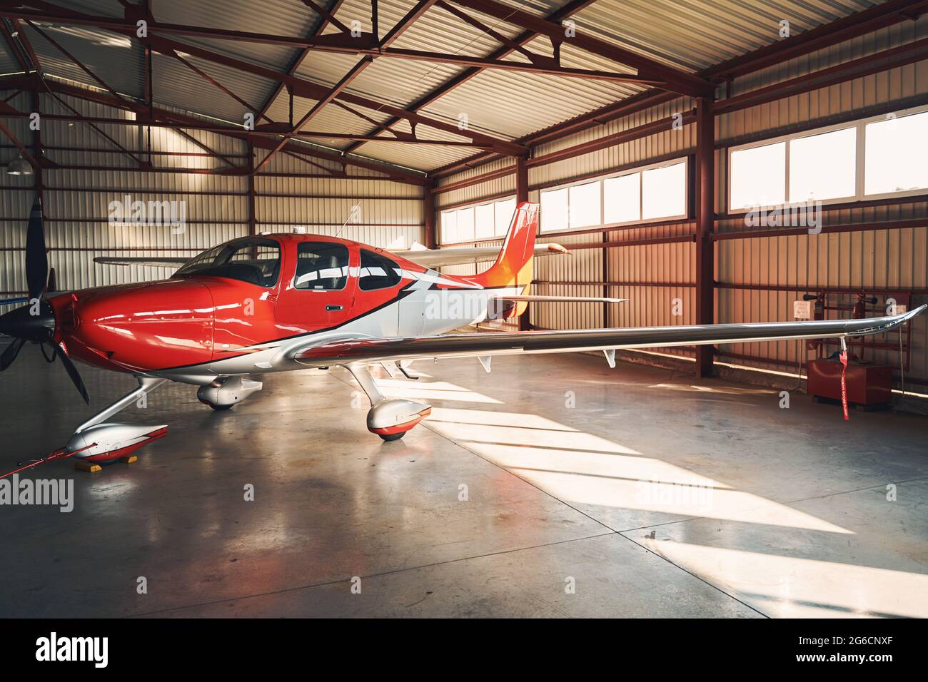 Modern aircraft in airport parking building hangar Stock Photo - Alamy