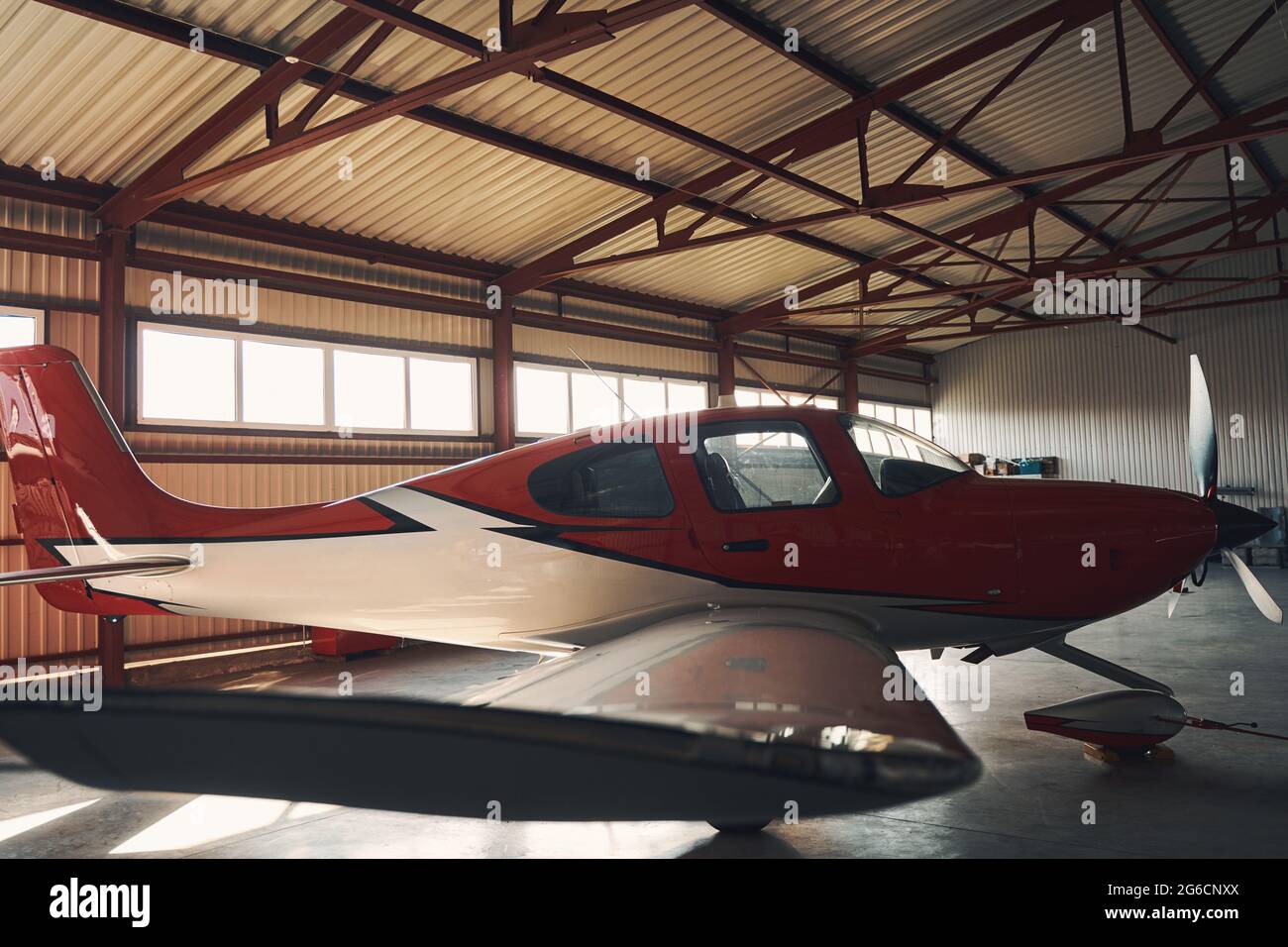 Modern light aircraft in airport parking building hangar Stock Photo ...