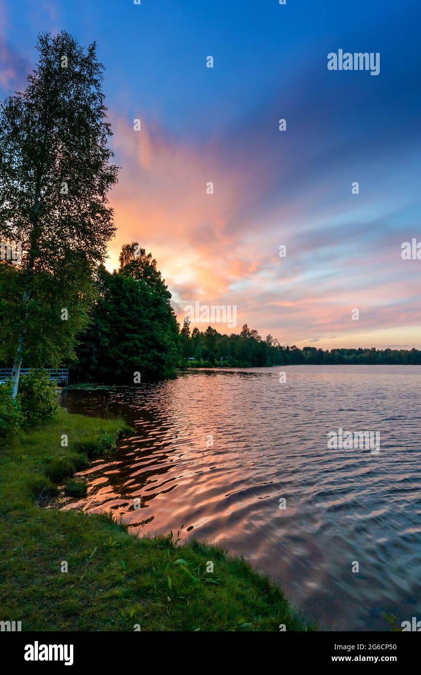 A vertical view of a beautiful summer sunset over a calm and idyllic ...