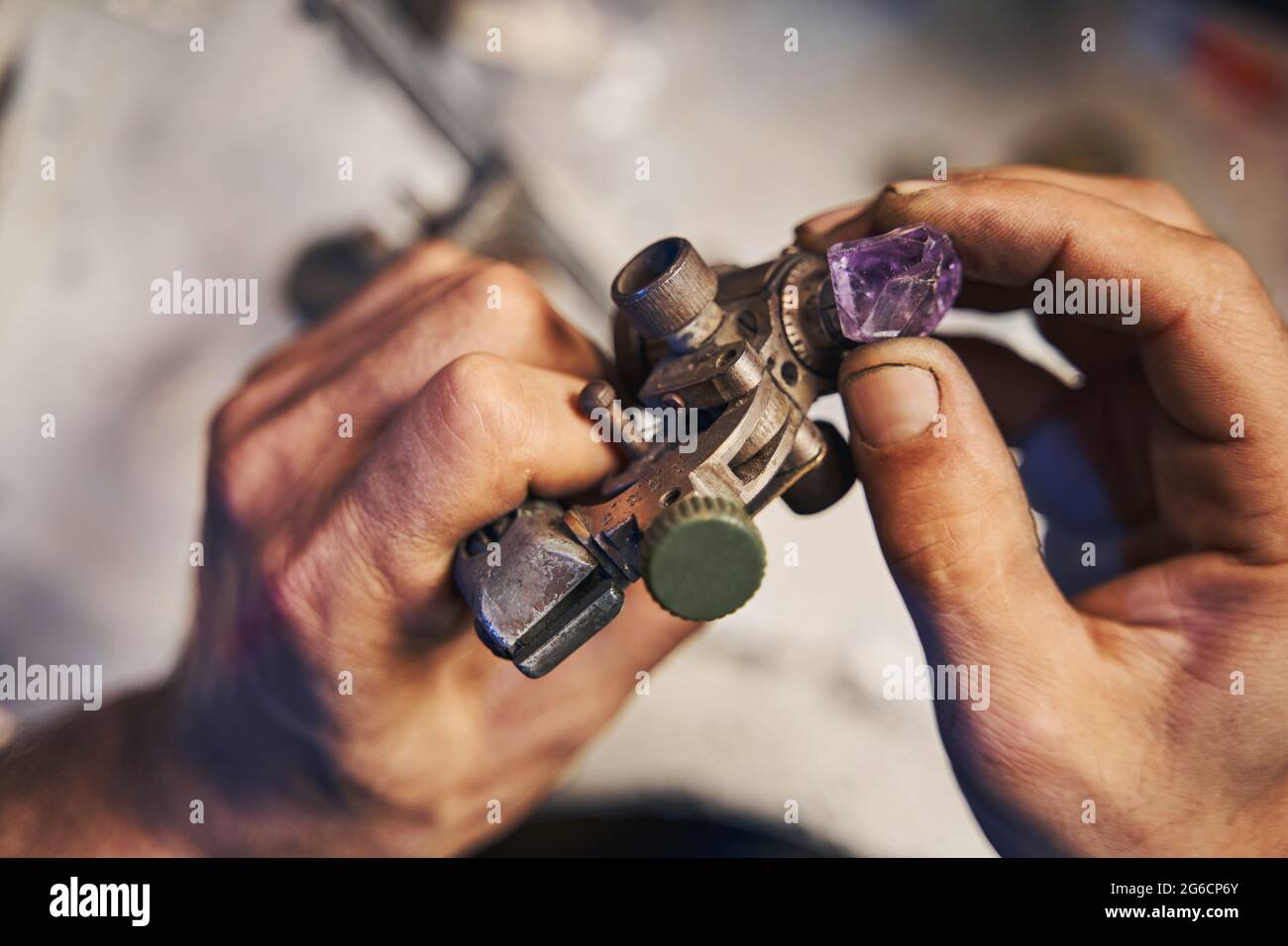 Gem-cutting tool used on amethyst during jewelry making process Stock ...