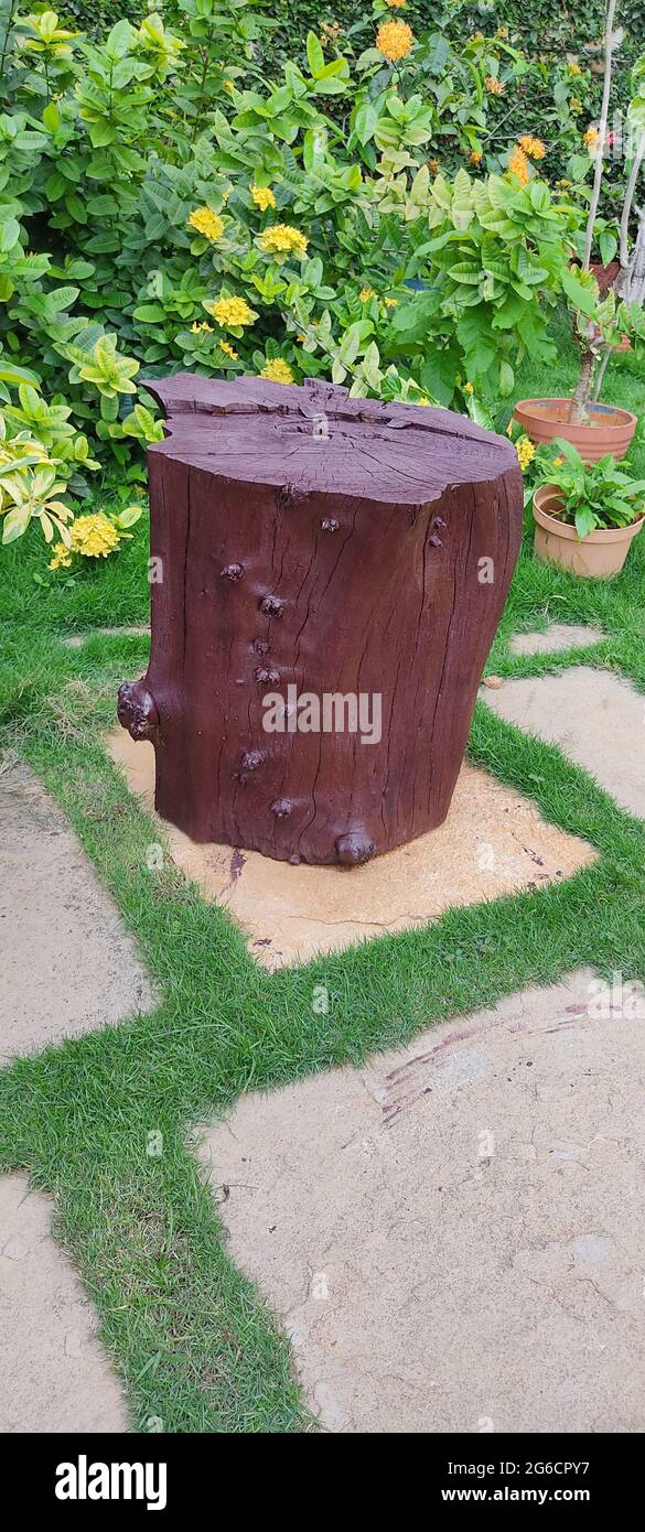 Chopped log in the garden decorated Stock Photo - Alamy