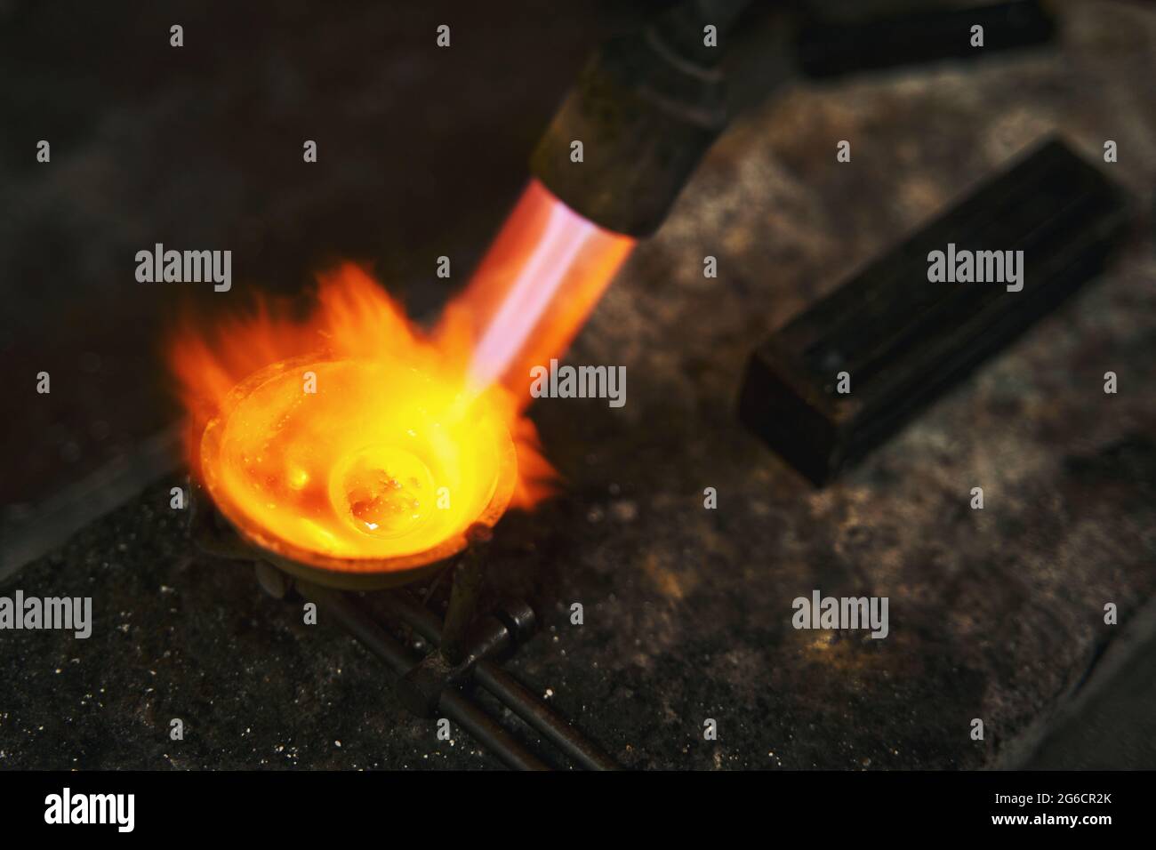 Flame from blowtorch melting metal for jewelry piece Stock Photo - Alamy