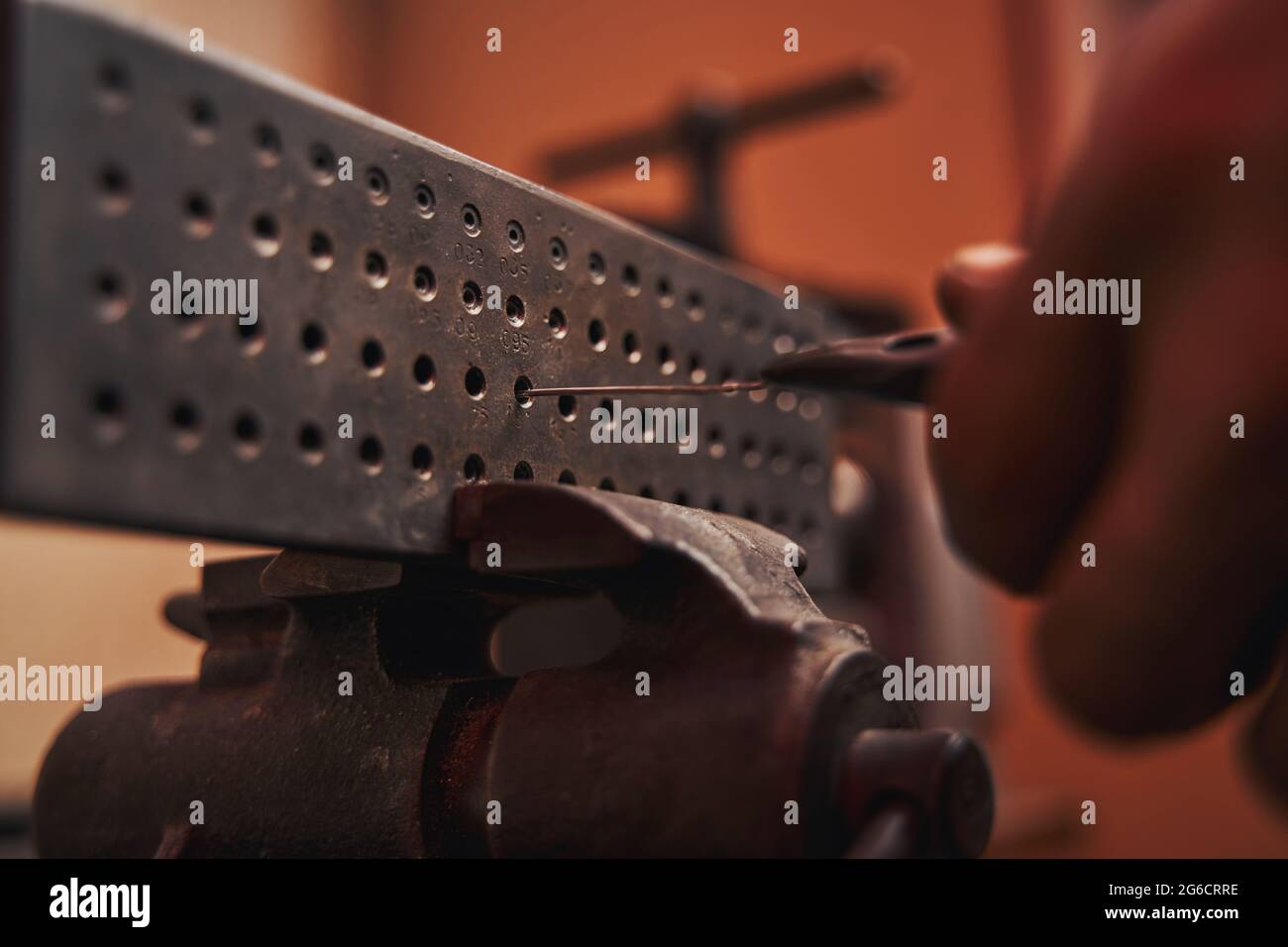 Craftsman doing wire drawing on draw plate Stock Photo - Alamy