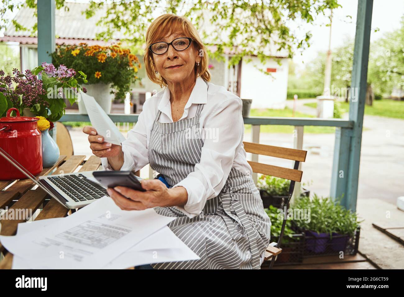 Beautiful mature lady using gadgets in terrace in countryside Stock ...