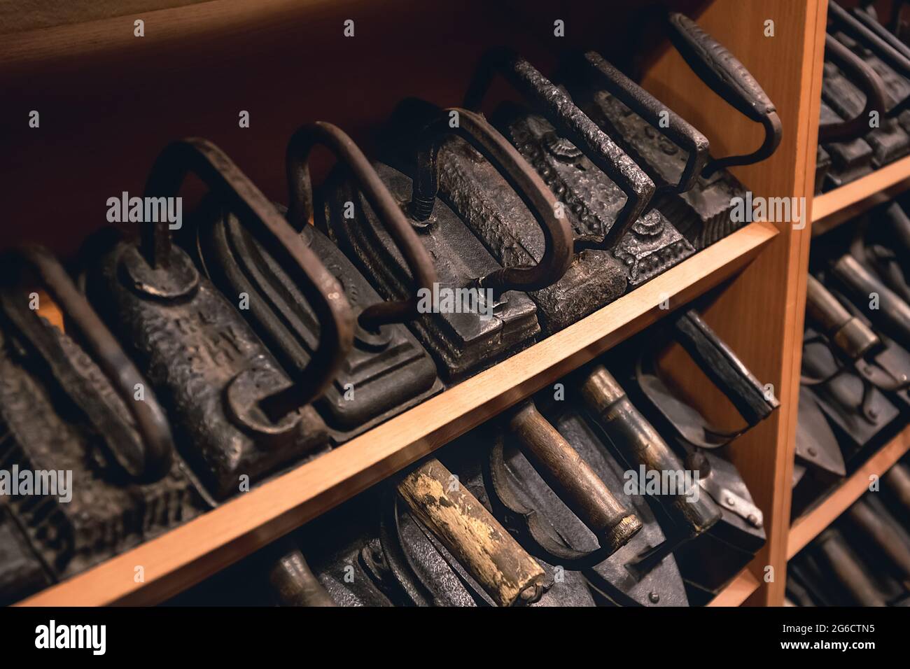 Collection of vintage irons for ironing clothes. Antique metal irons, a ...