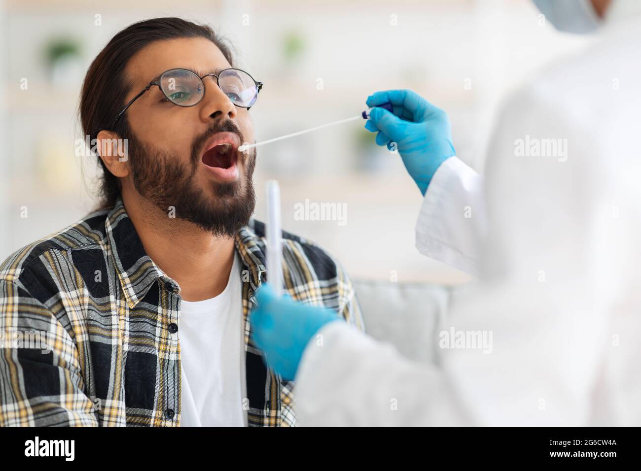 Indian guy getting coronavirus swab test at home Stock Photo - Alamy