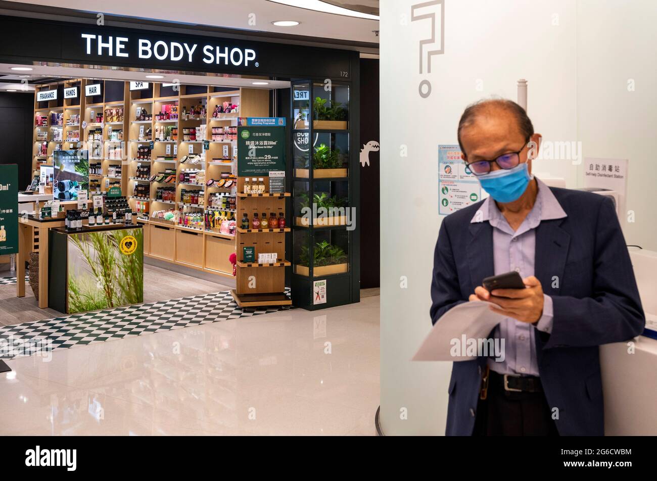 Hong Kong, China. 25th June, 2021. A shopper seen using his smartphone ...
