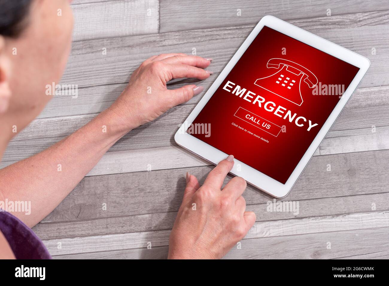 Woman using a tablet showing emergency concept Stock Photo - Alamy