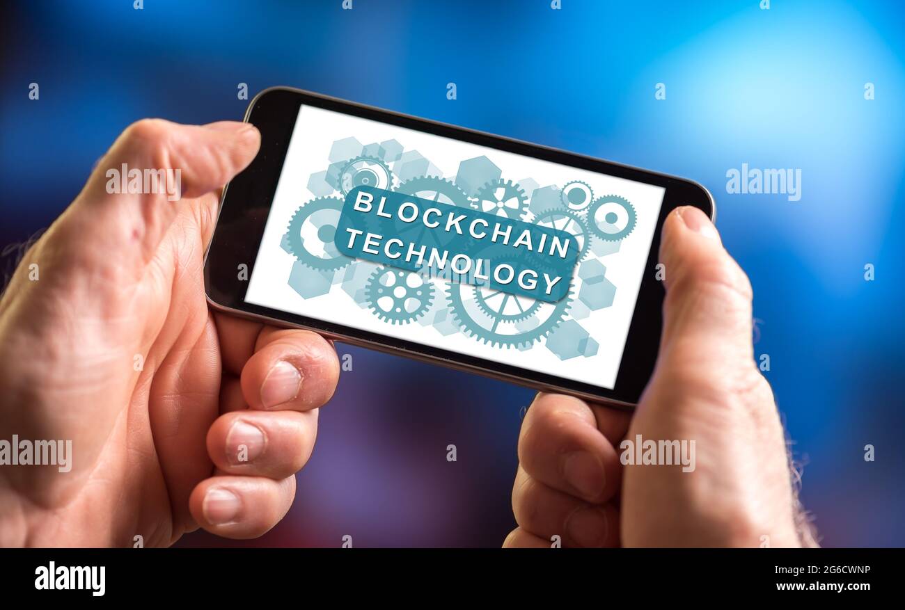 Hand holding a smartphone with blockchain technology concept Stock ...