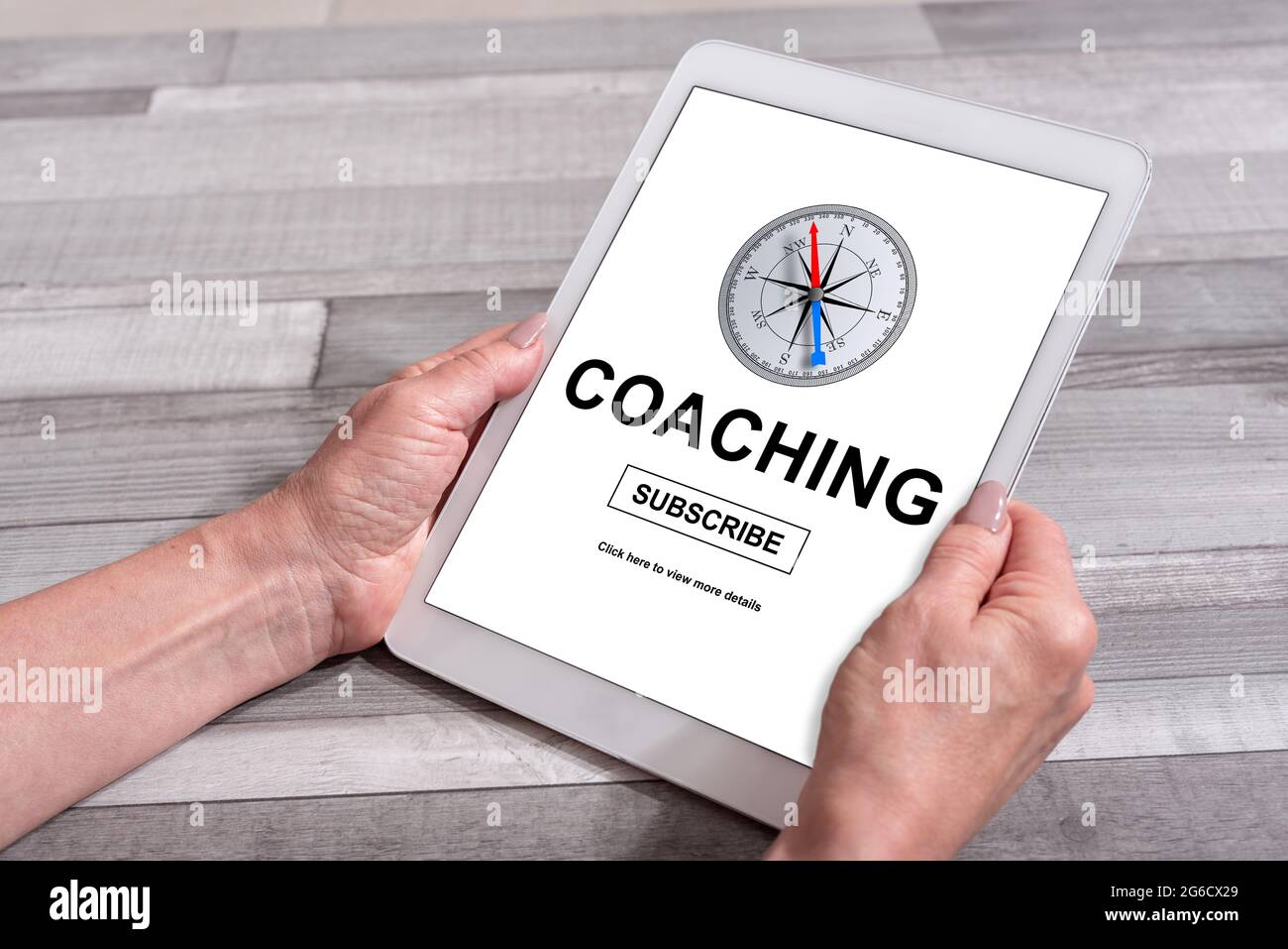 Female hands holding a tablet with coaching concept Stock Photo - Alamy