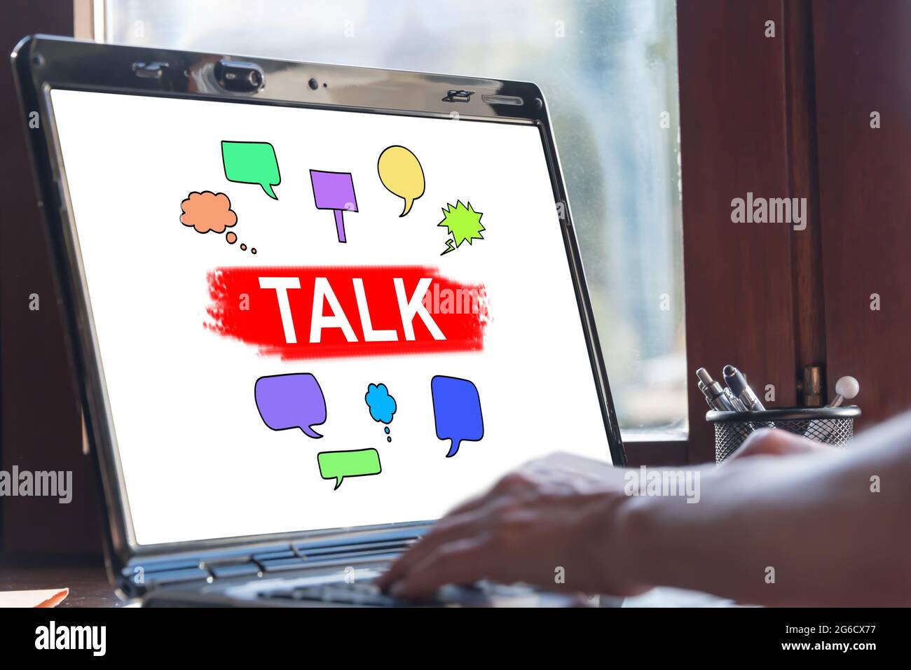 Laptop screen displaying a talk concept Stock Photo - Alamy