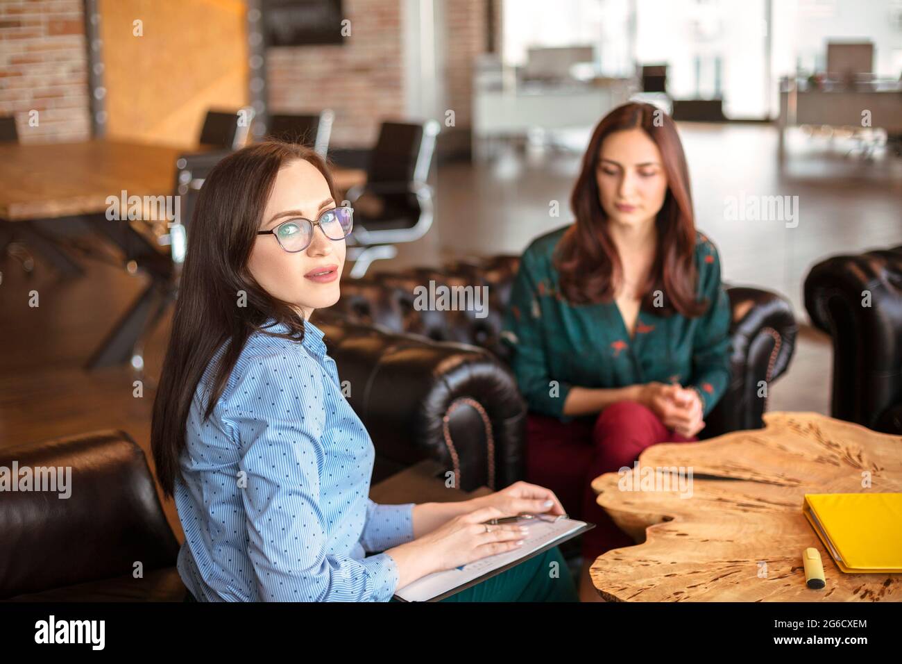 Elegant businesswoman interviewing female candidate while having ...