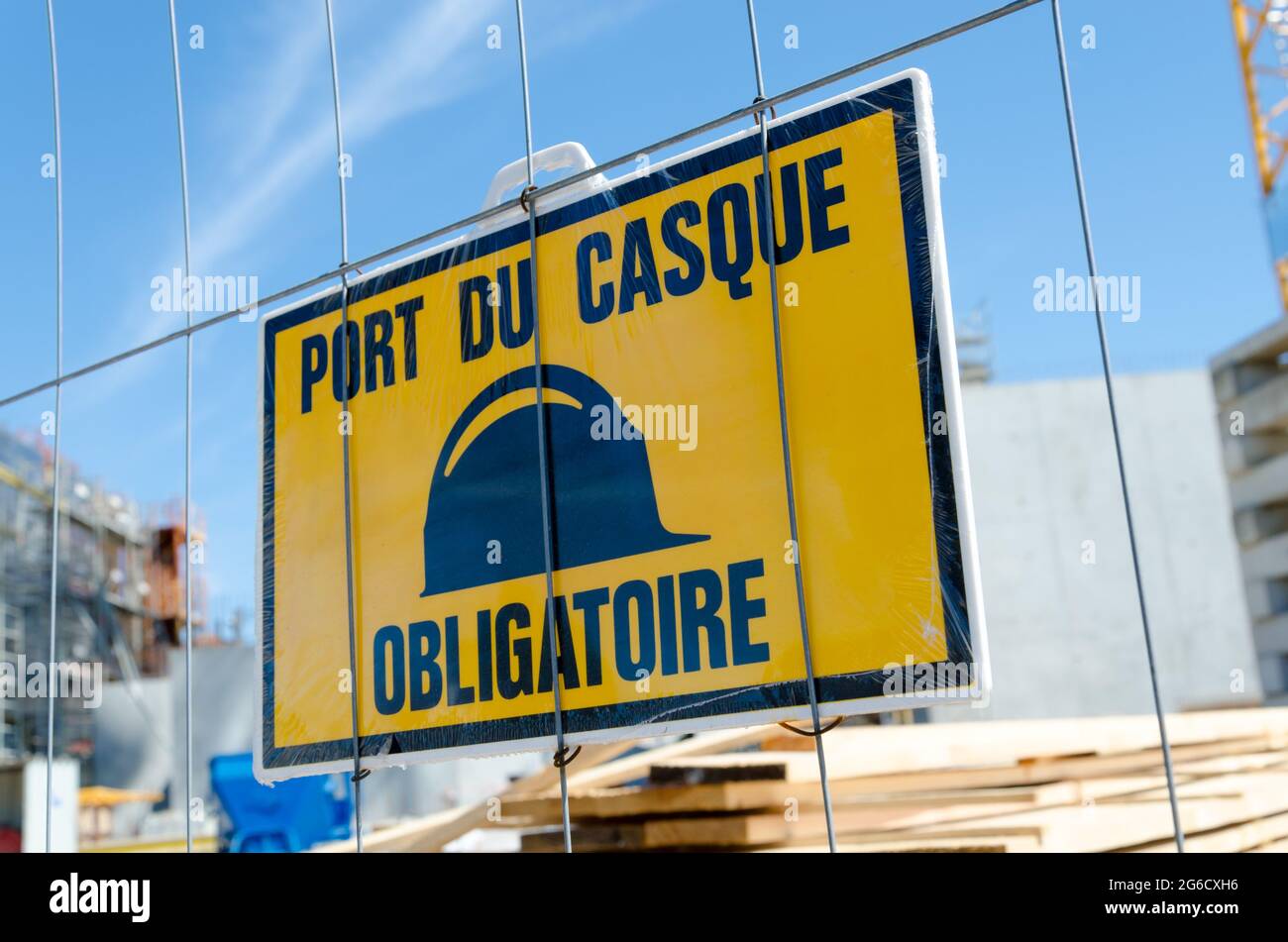 Mandatory helmet sign on construction site Stock Photo - Alamy