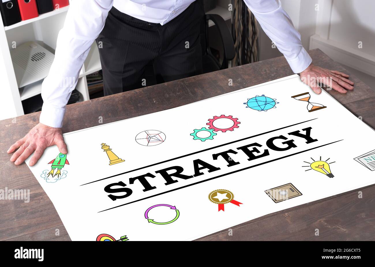 Man watching a strategy concept placed on a desk Stock Photo - Alamy