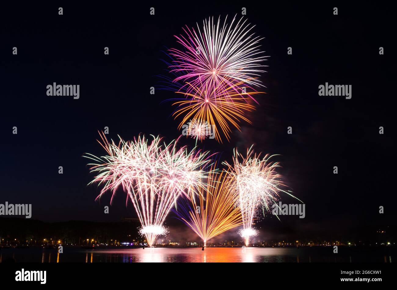 Beautiful fireworks show on a lake Stock Photo - Alamy