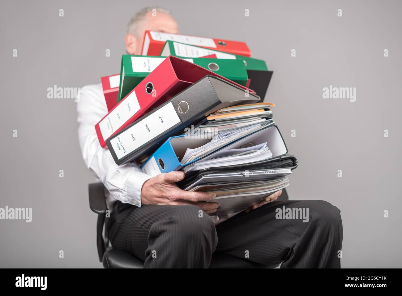 Businessman overloaded carrying a pile of binders and folders Stock ...