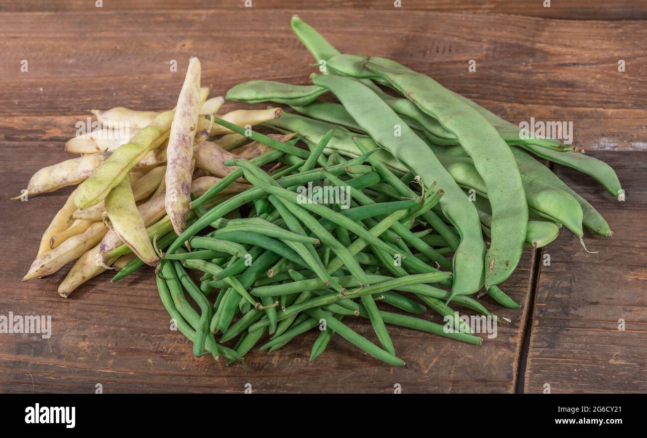 Green, runner and coco beans on wooden background Stock Photo - Alamy