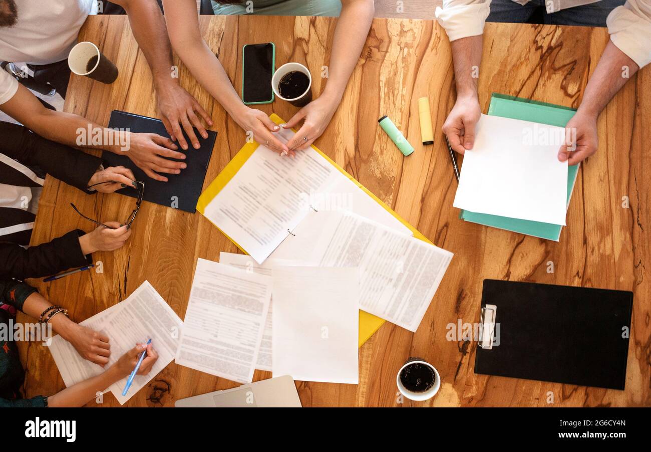 Business team hands on the table at work Stock Photo - Alamy