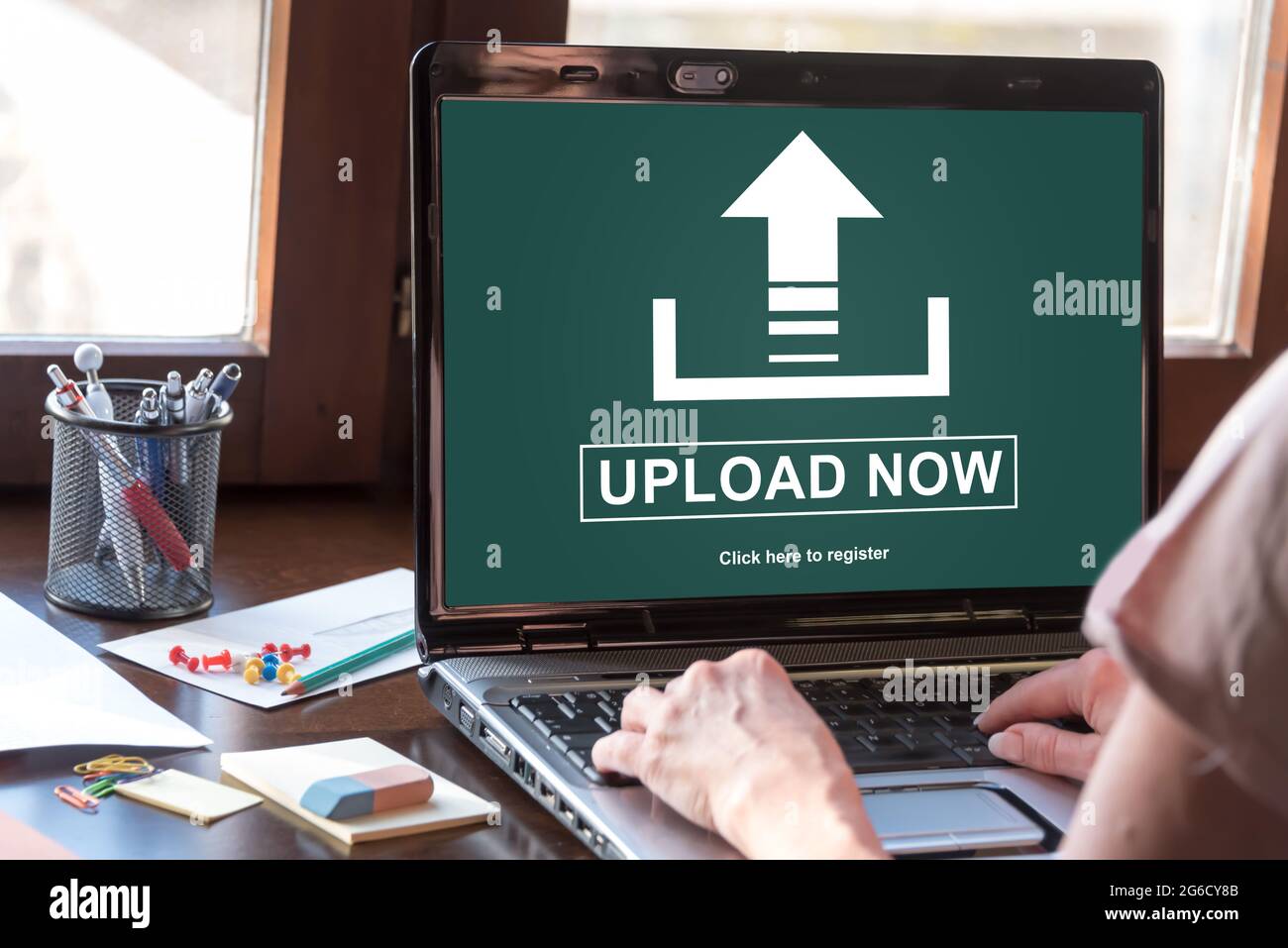 Laptop screen displaying an upload concept Stock Photo - Alamy