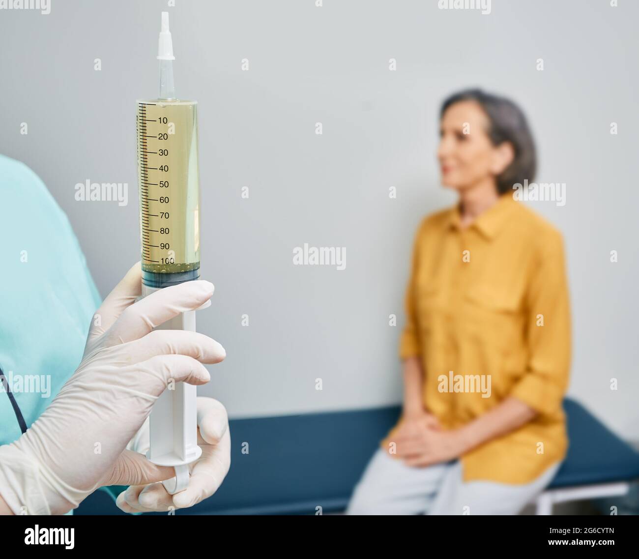 Syringe with medicinal solution in doctor's hand before doctor performs ...