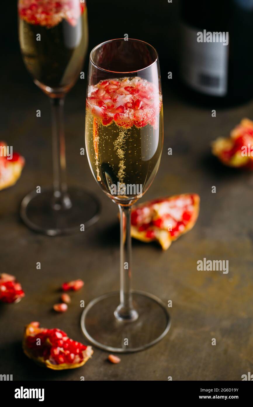 Still life composition of champagne cocktail with pomegranate on a ...