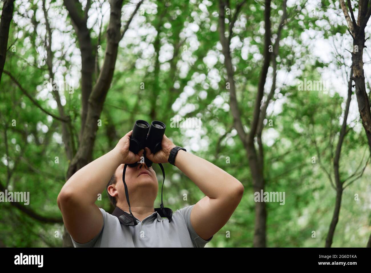 Man watching birds through binoculars hi-res stock photography and ...