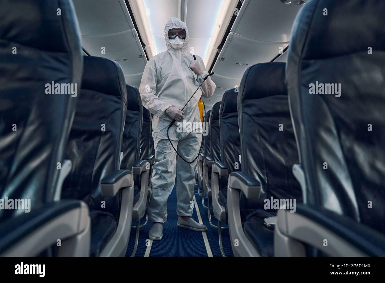 Airline worker in a hazmat suit posing for the camera Stock Photo - Alamy