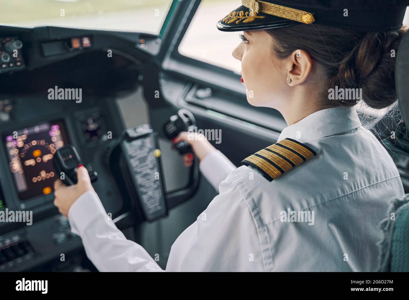 Serious concentrated female aviator piloting an aircraft Stock Photo ...