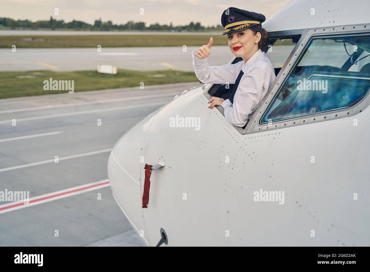 Confident lady pilot demonstrating her readiness for take-off Stock ...