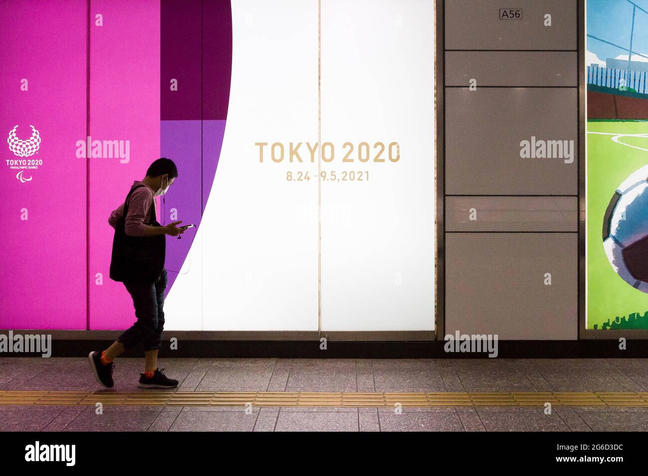 A man walks past Tokyo Paralympic posters in a passageway in Shinjuku ...