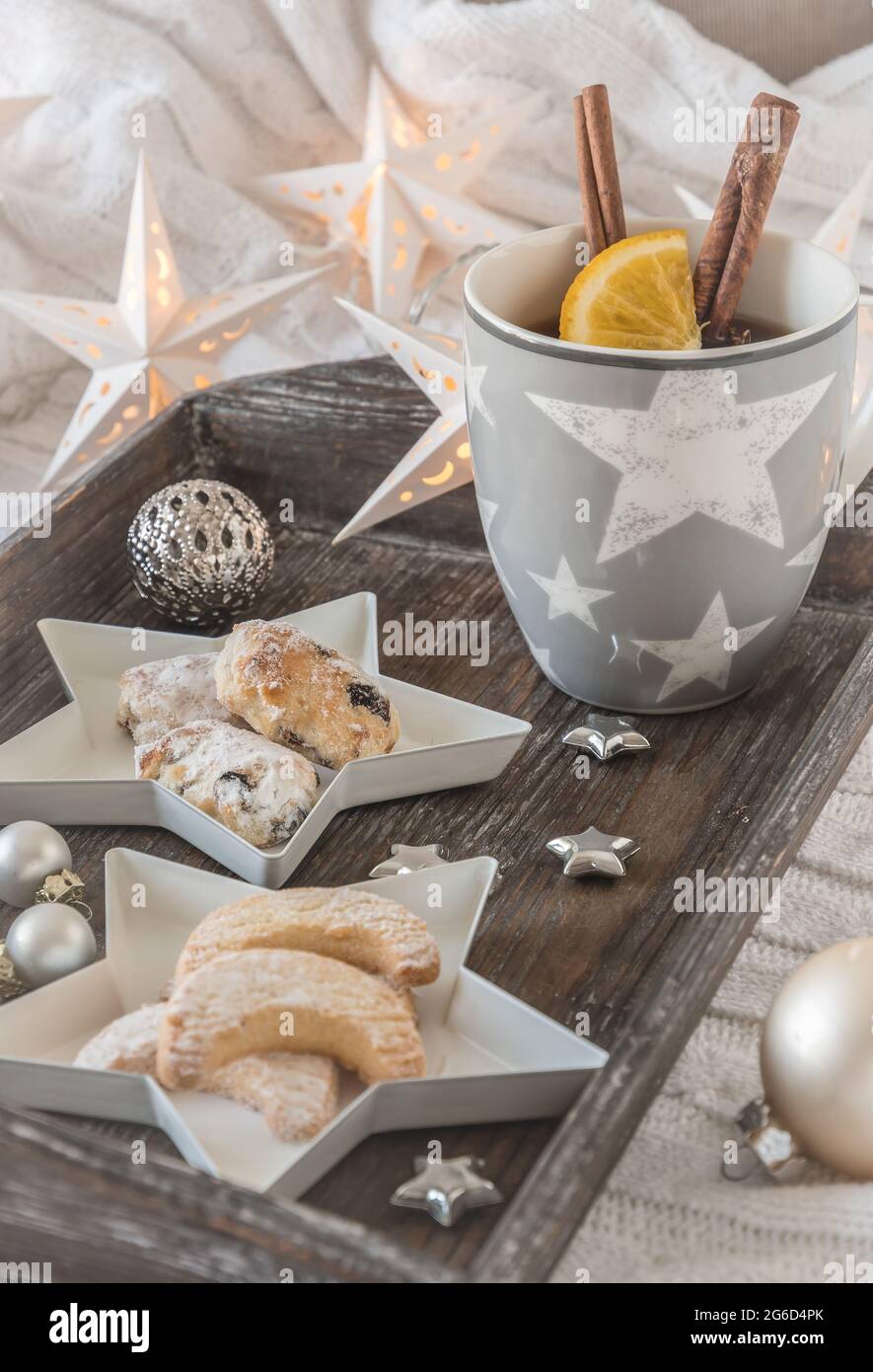 Cup of tea or punch and Christmas pastries on a wooden tray on a white ...
