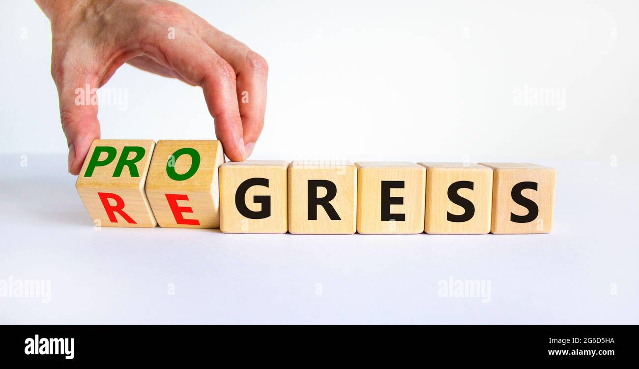 Regress or progress symbol. Businessman turns wooden cubes and changes ...