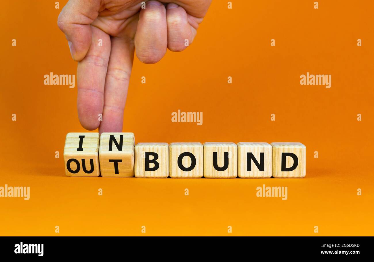 Inbound or outbound symbol. Businessman turns wooden cubes and changes ...